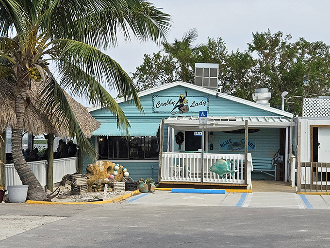 The turquoise beacon of seafood paradise! Crabby Lady's charming exterior promises Florida authenticity with every weathered board and welcoming ramp.