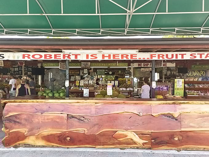 The wooden counter stretches like a rustic welcome mat, with "ROBERT IS HERE" proudly announcing itself to fruit pilgrims seeking tropical treasures.
