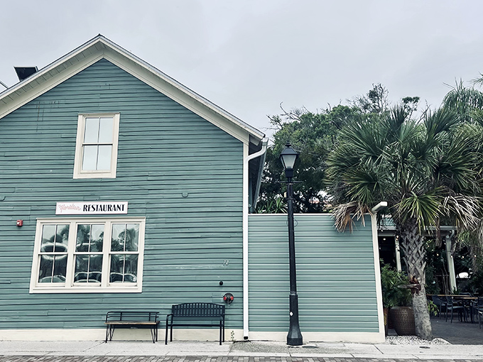 The seafoam-green exterior of The Floridian stands like a culinary lighthouse in St. Augustine's historic district, beckoning hungry travelers with Southern charm.