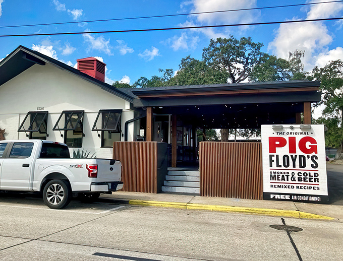 The inviting patio at Pig Floyd's welcomes barbecue pilgrims with playful pig artwork and comfortable outdoor seating&mdash;a carnivore's sanctuary in Orlando's Mills 50 district.