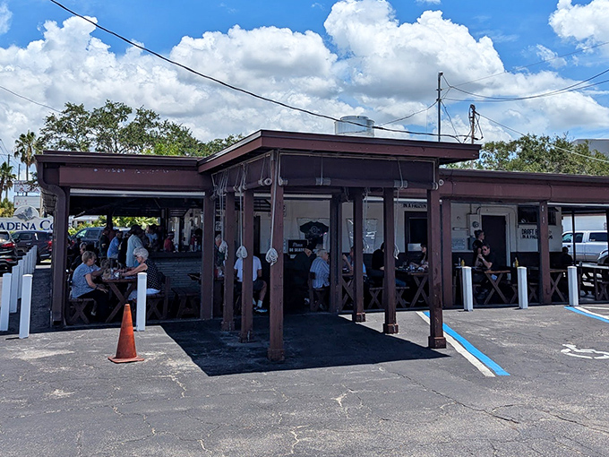The unassuming exterior of Ted Peters beckons with promises of smoky treasures within. No fancy frills, just Florida fish-shack perfection waiting to happen.