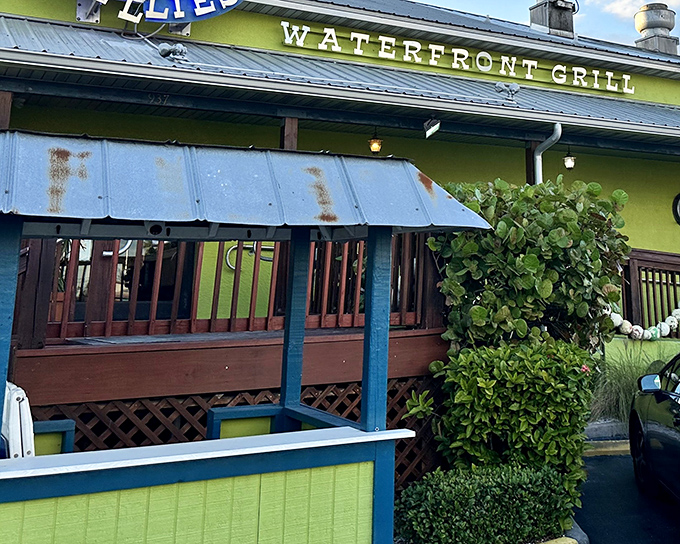 The vibrant lime-green exterior of Rusty Bellies stands out like a tropical oasis, promising seafood treasures within its cheerful walls.