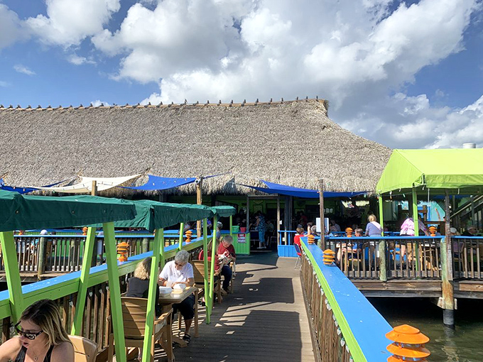 Paradise found! The thatched-roof tiki bar extends over the water, creating the perfect Florida escape where stress melts away with each gentle breeze.