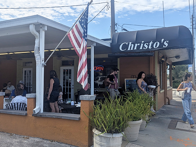 The coral-colored exterior of Christo's Caf&eacute; welcomes you with potted plants and outdoor seating&mdash;proof that culinary treasures often hide in unassuming packages.
