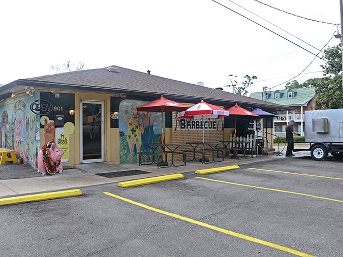 The unassuming yellow exterior of Hot Spot Barbecue, where those red umbrellas aren't just for show&mdash;they're beacons guiding hungry souls to barbecue nirvana.