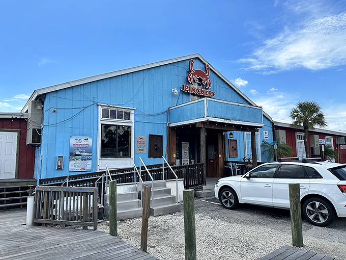 Pinchers' cheerful blue exterior beckons seafood lovers like a coastal lighthouse, promising treasures from the deep just steps from the water.