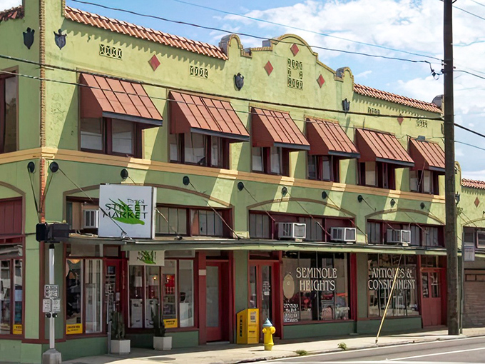 The historic facade of Retro Mania Vintage Market stands proudly in Tampa's Seminole Heights, its Spanish-influenced architecture and terracotta awnings practically whispering "come treasure hunting."