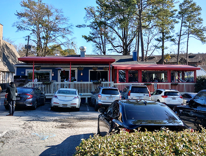 The blue cottage with its striking red awnings stands like a breakfast beacon in Buckhead, promising morning delights worth any wait.