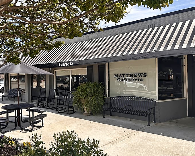 The unassuming storefront with its striped awning and rocking chairs whispers a promise that grandma-approved comfort food awaits inside.