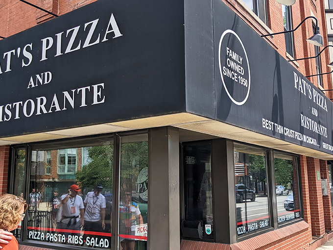 The iconic corner sign glows like a beacon for pizza pilgrims. Pat's Pizza & Ristorante stands proudly against the Chicago night sky.