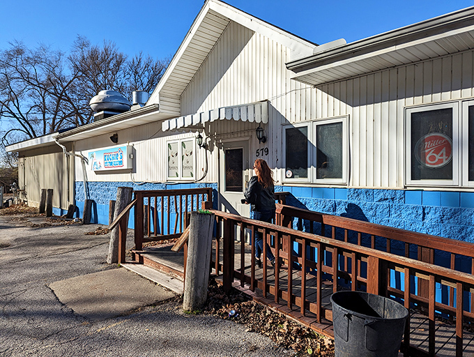 The unassuming blue-trimmed exterior of Kuchie's on the Water might not scream "culinary destination," but that's part of its charm—the real magic awaits inside.