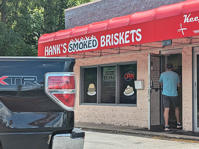 The bright red awning of Hank's stands out like a beacon for barbecue pilgrims, promising smoky salvation inside this unassuming Indianapolis treasure.