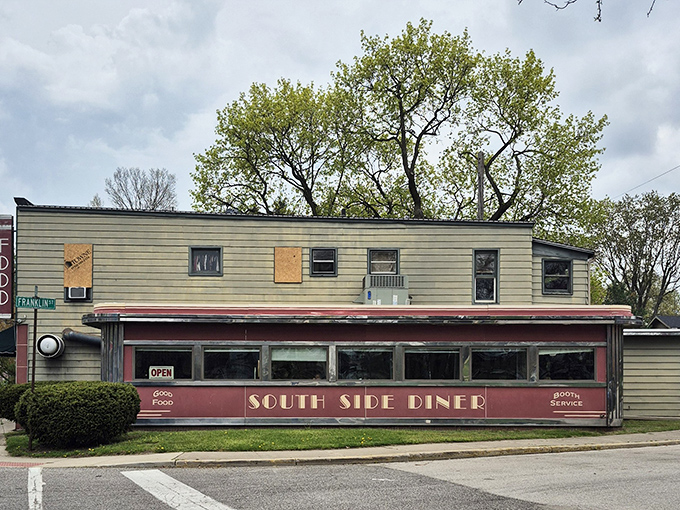 The classic red facade of South Side Soda Shop stands like a time capsule on Goshen's Main Street, complete with blue umbrellas that beckon hungry travelers to slow down and savor.