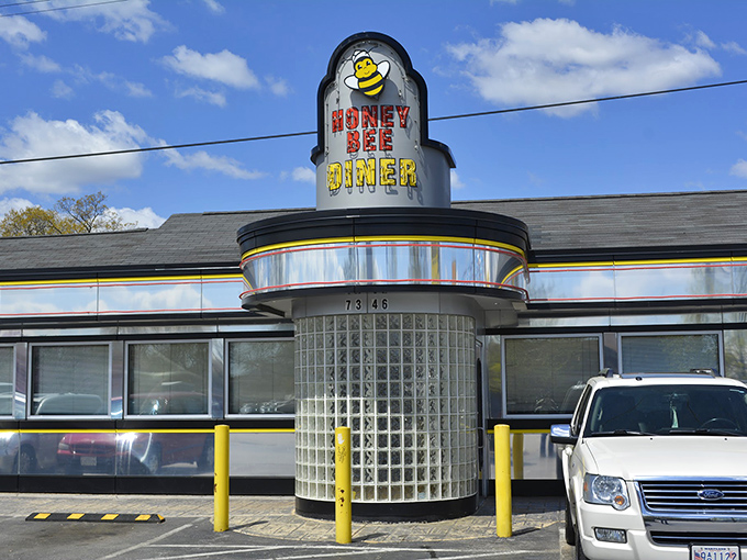 The iconic Honey Bee Diner exterior gleams like a beacon of breakfast hope on Ritchie Highway, its cheerful bee mascot promising sweet satisfaction ahead.