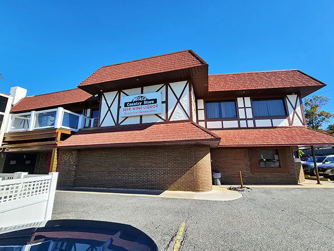 The Tudor-style charm of Mike's Crabhouse stands proudly against Maryland's blue skies, promising seafood treasures within those distinctive red-tiled roofs.