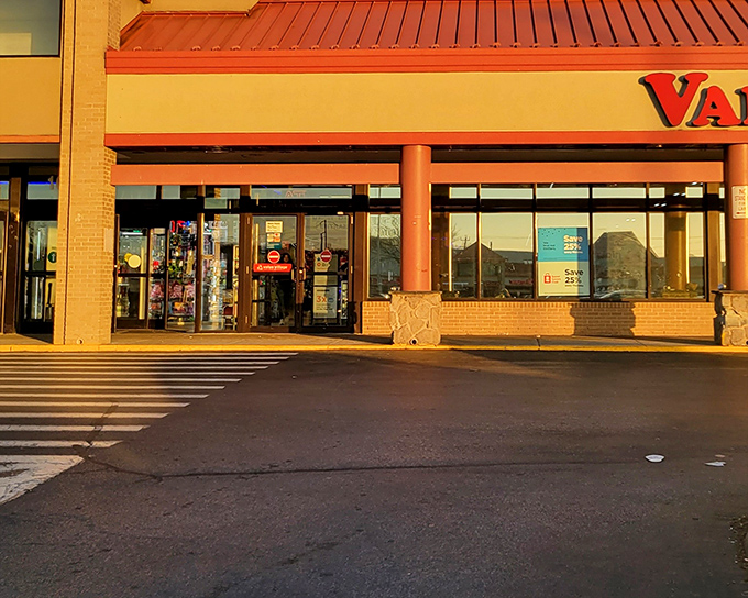 The iconic red Value Village sign beckons like a lighthouse for bargain hunters, promising treasures within those sliding glass doors.