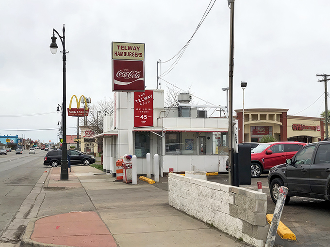 The iconic white and red exterior of Telway stands like a time capsule on Michigan Avenue, beckoning burger lovers with its retro charm and unmistakable presence.