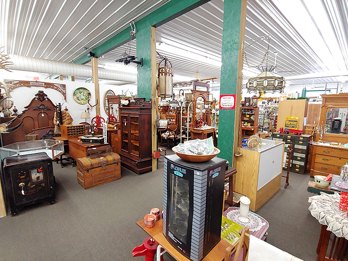 The warm wooden interior of Hog Creek Antique Mall beckons treasure hunters with its labyrinth of vendor booths&mdash;a paradise where history whispers from every shelf.
