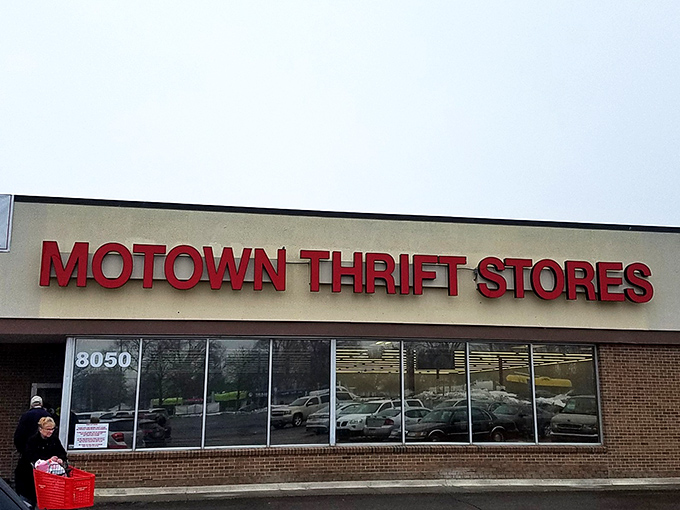 The iconic red Motown Thrift sign beckons bargain hunters like a retail lighthouse, promising treasures within this unassuming Westland storefront.