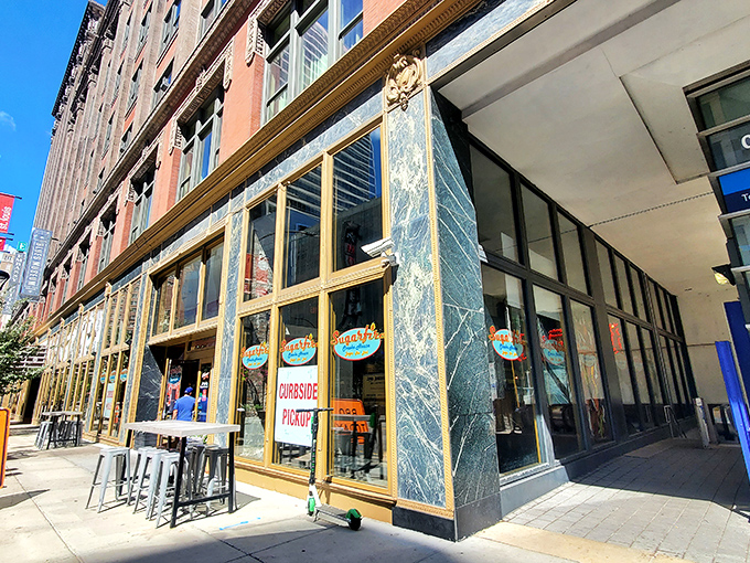 The golden-framed entrance to Sugarfire beckons like a portal to meat paradise. Those flames on the logo? A delicious warning of what's to come.