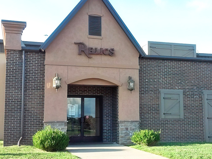 The unassuming exterior of Relics Antique Mall hides a universe of treasures within, like a TARDIS disguised as a strip mall storefront.