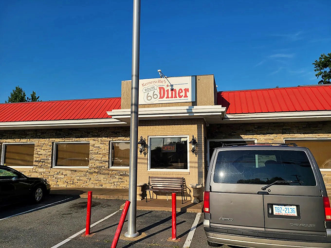 That red roof and stone facade might look modest, but inside lies culinary magic that locals treasure.