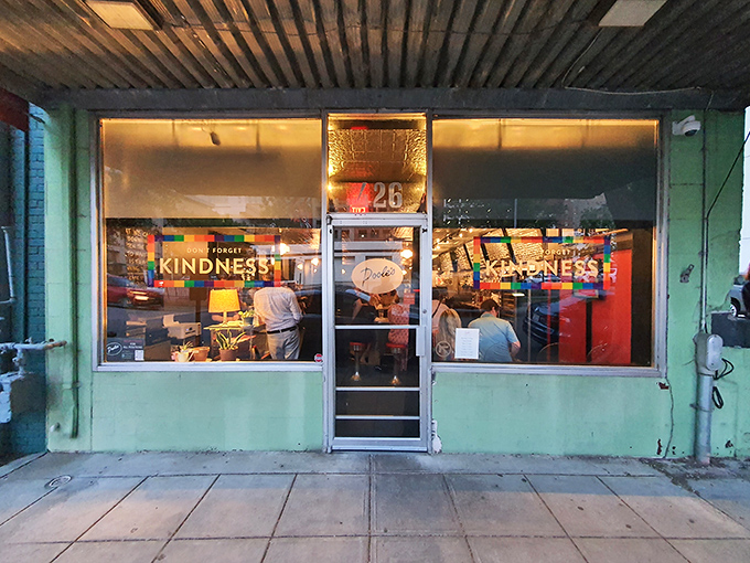 The turquoise facade of Pooleside Pies glows like a beacon for hungry souls, promising comfort in neon-lit form.