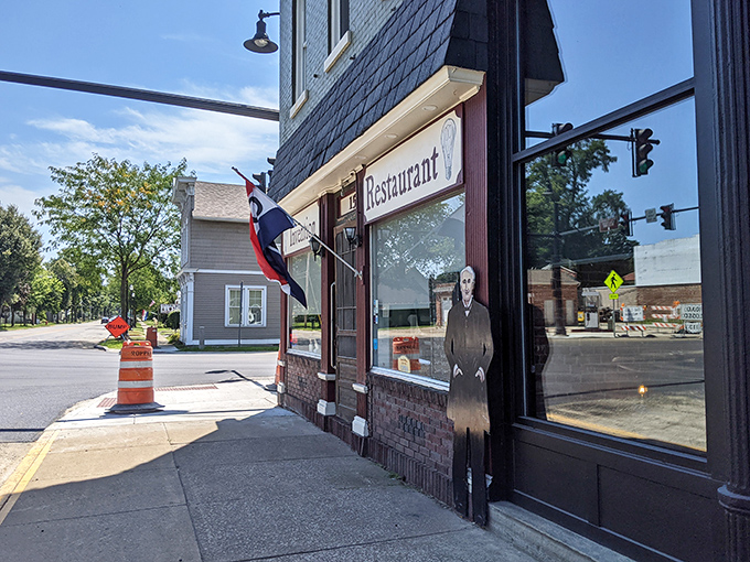 The iconic facade of Invention Restaurant, where a Thomas Edison cutout stands guard, reminding visitors they're about to experience some truly illuminating comfort food.