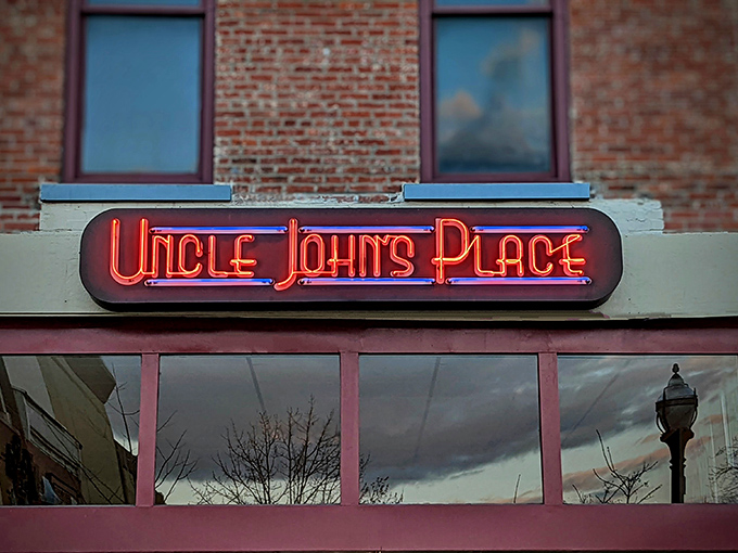 The neon glow of Uncle John's Place sign beckons like a lighthouse for the hungry. Downtown Mansfield's worst-kept culinary secret since 1977.