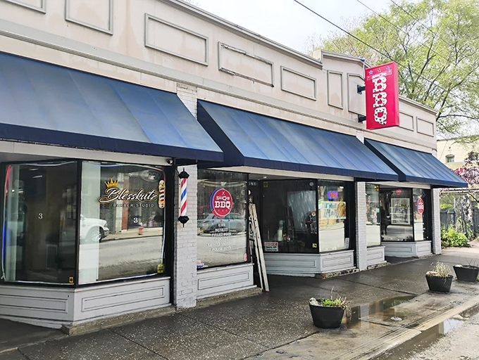 The unassuming exterior of Real Smoq'ed BBQ gives no hint of the flavor explosion waiting inside. Blue awnings and a simple storefront hide Cleveland's best-kept barbecue secret.