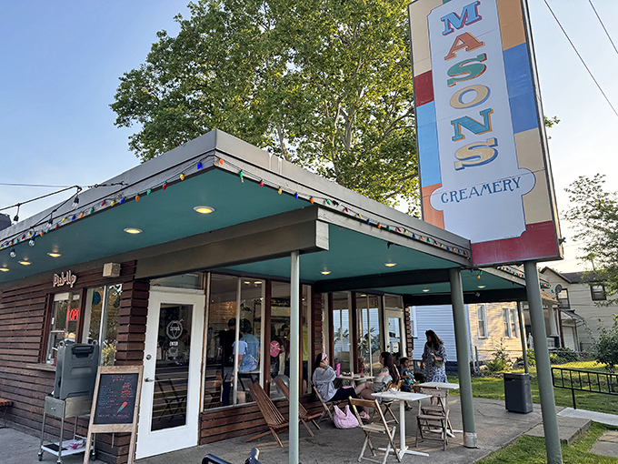 Mason's Creamery stands like a sweet oasis in Cleveland's Ohio City neighborhood, its colorful sign promising frozen delights under string lights and summer skies.