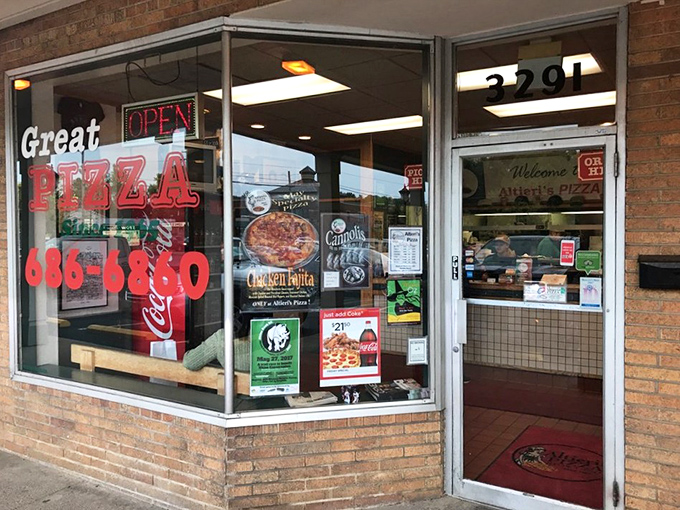 The teal and pink neon sign of Altieri's Pizza glows like a beacon of hope for the hungry in Stow Plaza. Comfort food paradise awaits!