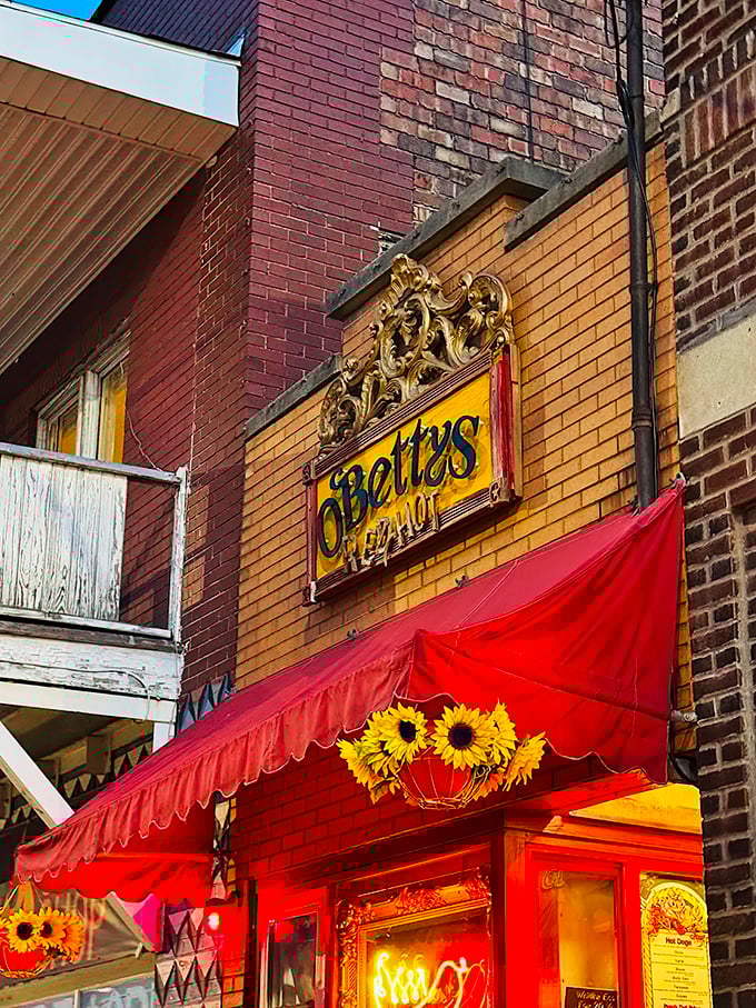 That red awning beckons like a culinary lighthouse, promising hot dog adventures beyond your wildest dreams.
