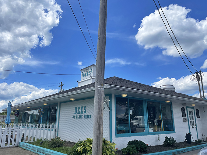 The turquoise trim against crisp white siding isn't just eye-catching&mdash;it's a beacon for hungry travelers promising authentic 50s diner magic inside.
