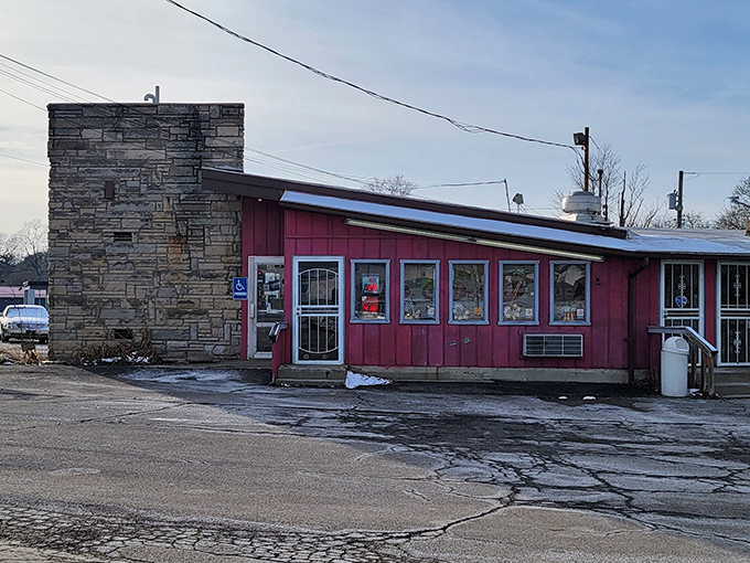The unassuming red exterior of Porky's Drive-In stands like a time capsule on Ashland Road, promising honest food without pretense since 1949.