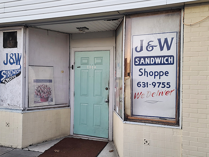 The unassuming blue door of J&W Sandwich Shoppe stands like a portal to sandwich nirvana. No fancy signage needed when the food speaks this loudly.
