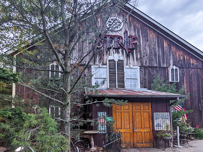 A rustic barn reborn as a culinary destination. Strip Steakhouse's weathered exterior and bright wooden doors promise delicious secrets within.