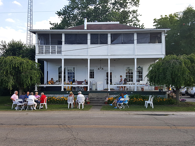 The white clapboard building stands like a time capsule, complete with porch seating where ice cream and conversation flow in equal measure.