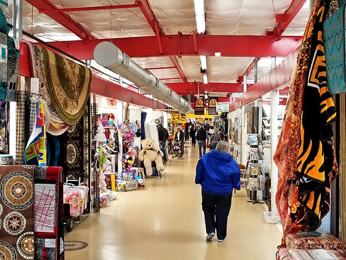The main corridor stretches like a retail yellow brick road, promising treasures at every turn. Shoppers stroll beneath red beams, hunting for their next great find.