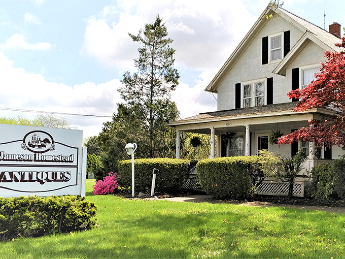 The classic white farmhouse exterior of Jameson Homestead Antiques stands like a time capsule waiting to be opened, complete with inviting porch and vintage charm.