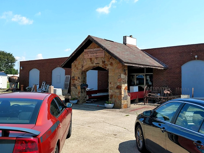 The stone facade of Leroy's Antiques & Collectibles stands like a humble guardian of treasures past, its wooden sign promising adventures in nostalgia beneath the Ohio sky.