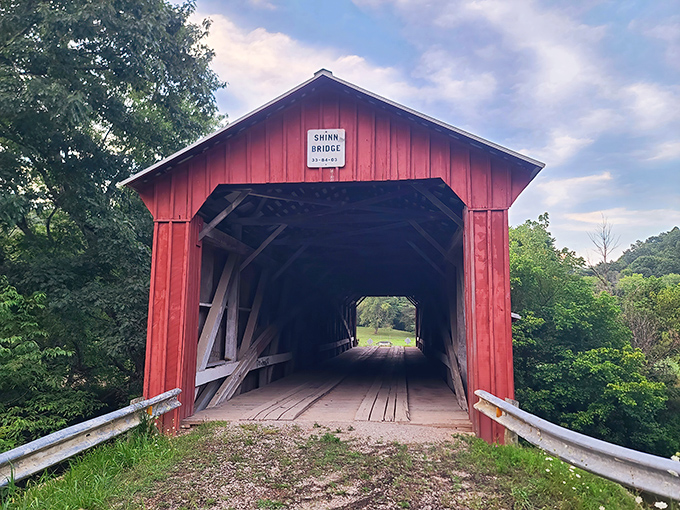 The crimson facade of Shinn Bridge stands like a portal to another era, inviting travelers to step back in time while crossing Wolf Creek.