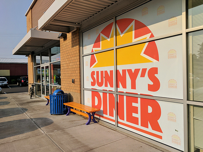 The bright sun logo beckons like a breakfast lighthouse, promising morning salvation in brick-and-mortar form at Happy Valley's beloved Sunny's Diner.