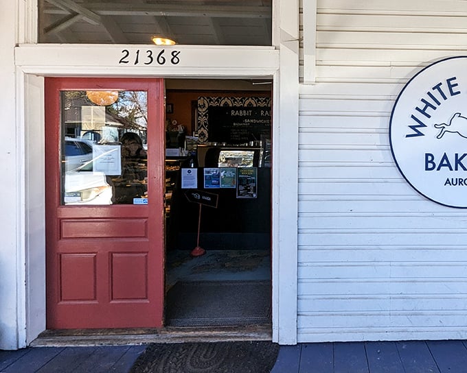 The unassuming exterior of White Rabbit Bakery, with its coral-colored doors, proves once again that the best culinary treasures often hide in plain sight.