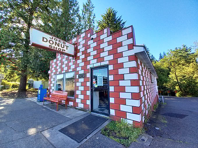 The red and white checkerboard exterior of Joe's Donut Shop stands like a sugary mirage on Highway 26, beckoning hungry travelers with promises of fried dough paradise.