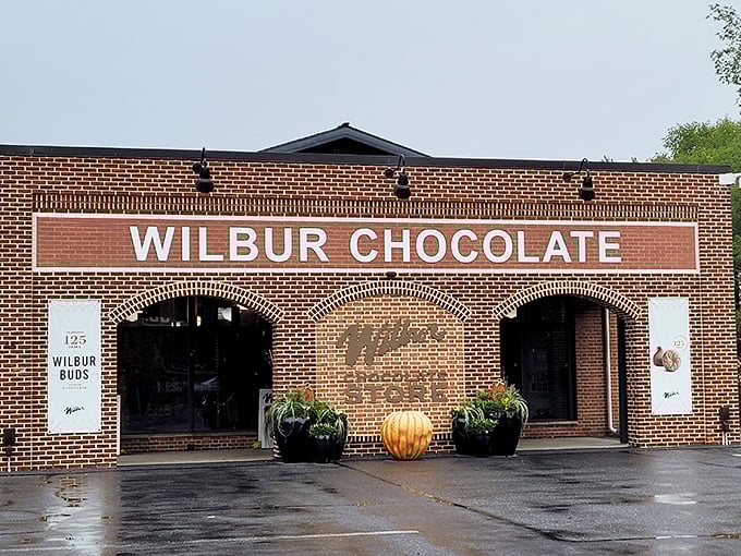 The brick facade of Wilbur Chocolate Store stands like a temple to cocoa worship, beckoning chocolate pilgrims with its timeless charm and promise of sweet revelations inside.