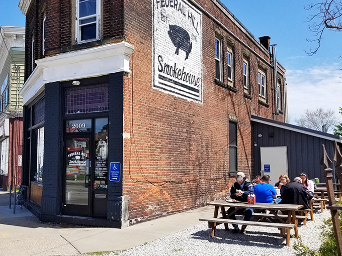 The unassuming brick exterior of Federal Hill Smokehouse stands like a barbecue beacon in Erie, complete with picnic tables where smoke-scented dreams come true.