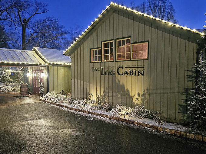The Log Cabin's twilight glow welcomes hungry travelers with twinkling lights and rustic charm, like a culinary firefly beckoning from Amish Country.