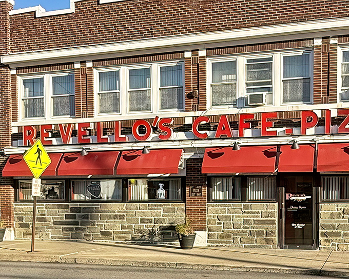 The iconic red awnings and vintage signage of Revello's stand as a beacon to pizza pilgrims seeking Old Forge's rectangular revelation.