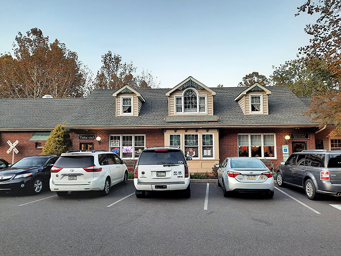 Moccia's Train Stop welcomes hungry travelers with its charming brick-and-siding exterior, complete with railroad crossing signs that hint at culinary journeys ahead.